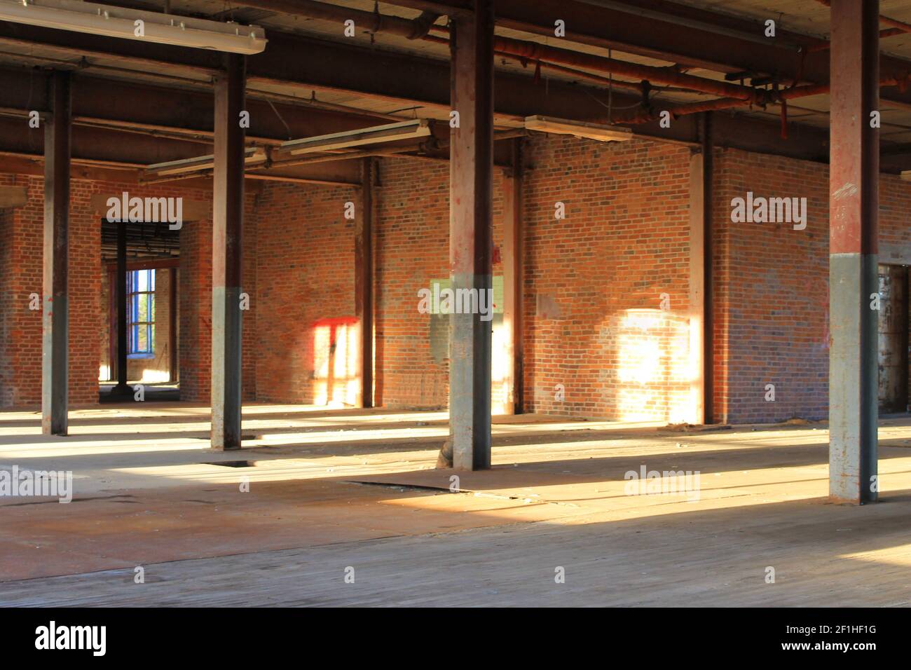 Interior view of an old, run-down, and abandoned factory building. Big ...