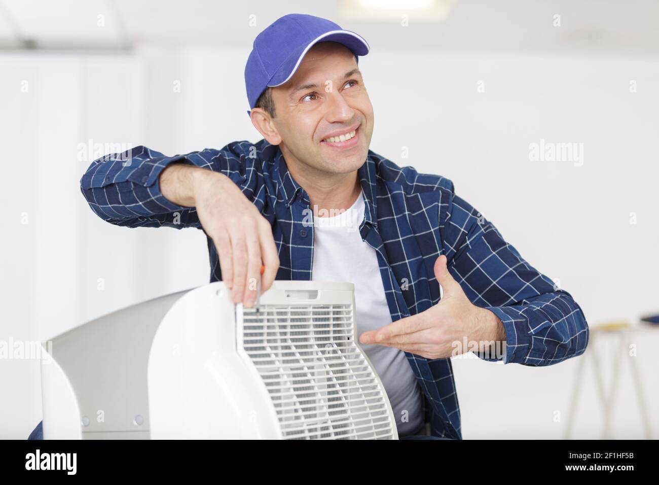 happy man operates air conditioner Stock Photo - Alamy