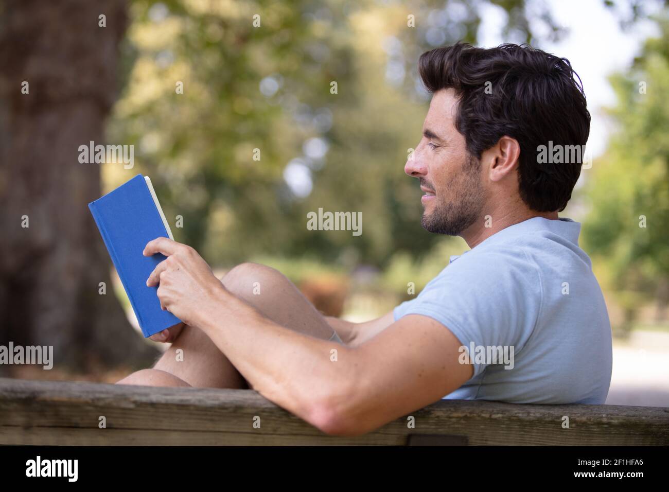 Seated man pointing book hi-res stock photography and images - Alamy