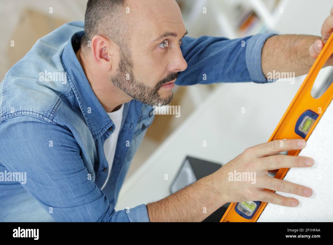 a middle aged man with aluminum level Stock Photo - Alamy