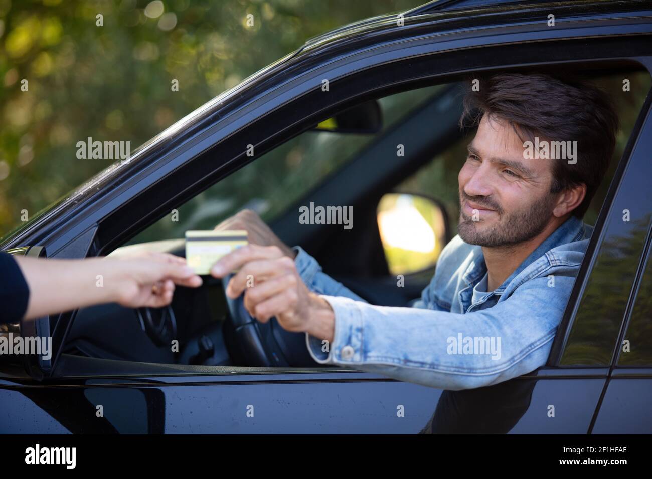 male driver making card payment Stock Photo - Alamy