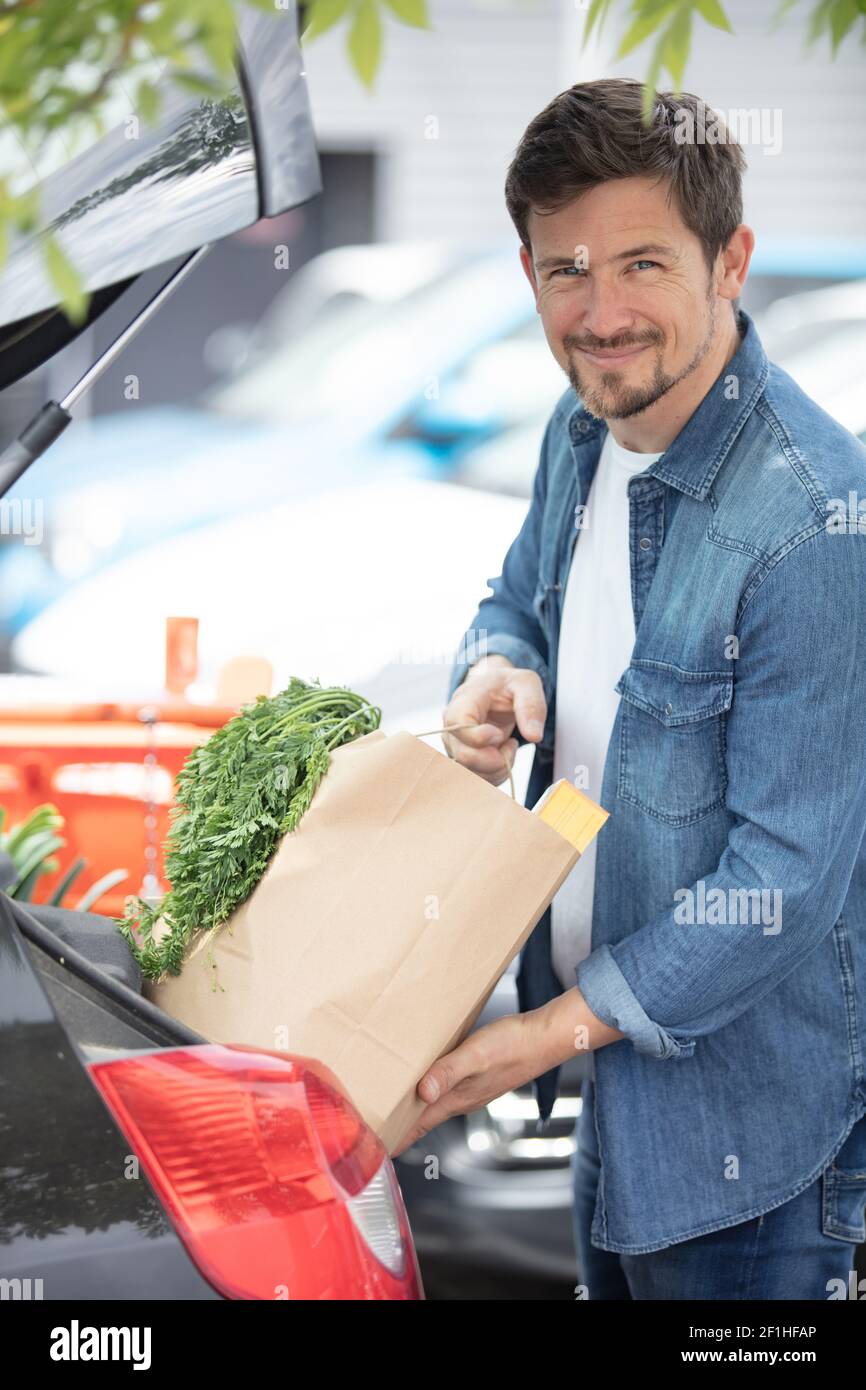 man going with cart on shopping mall parking Stock Photo - Alamy