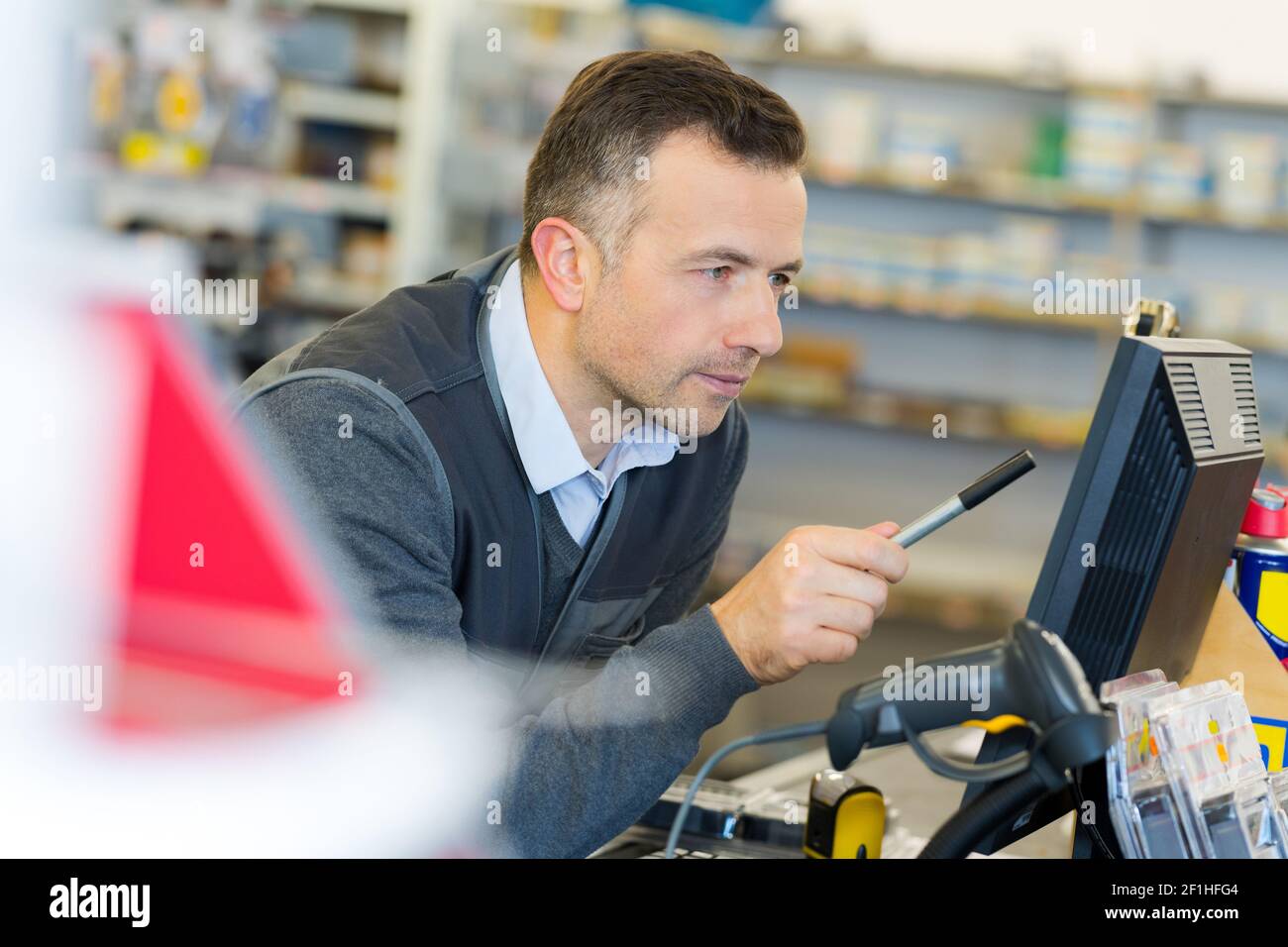 man using computer in hardware store Stock Photo - Alamy