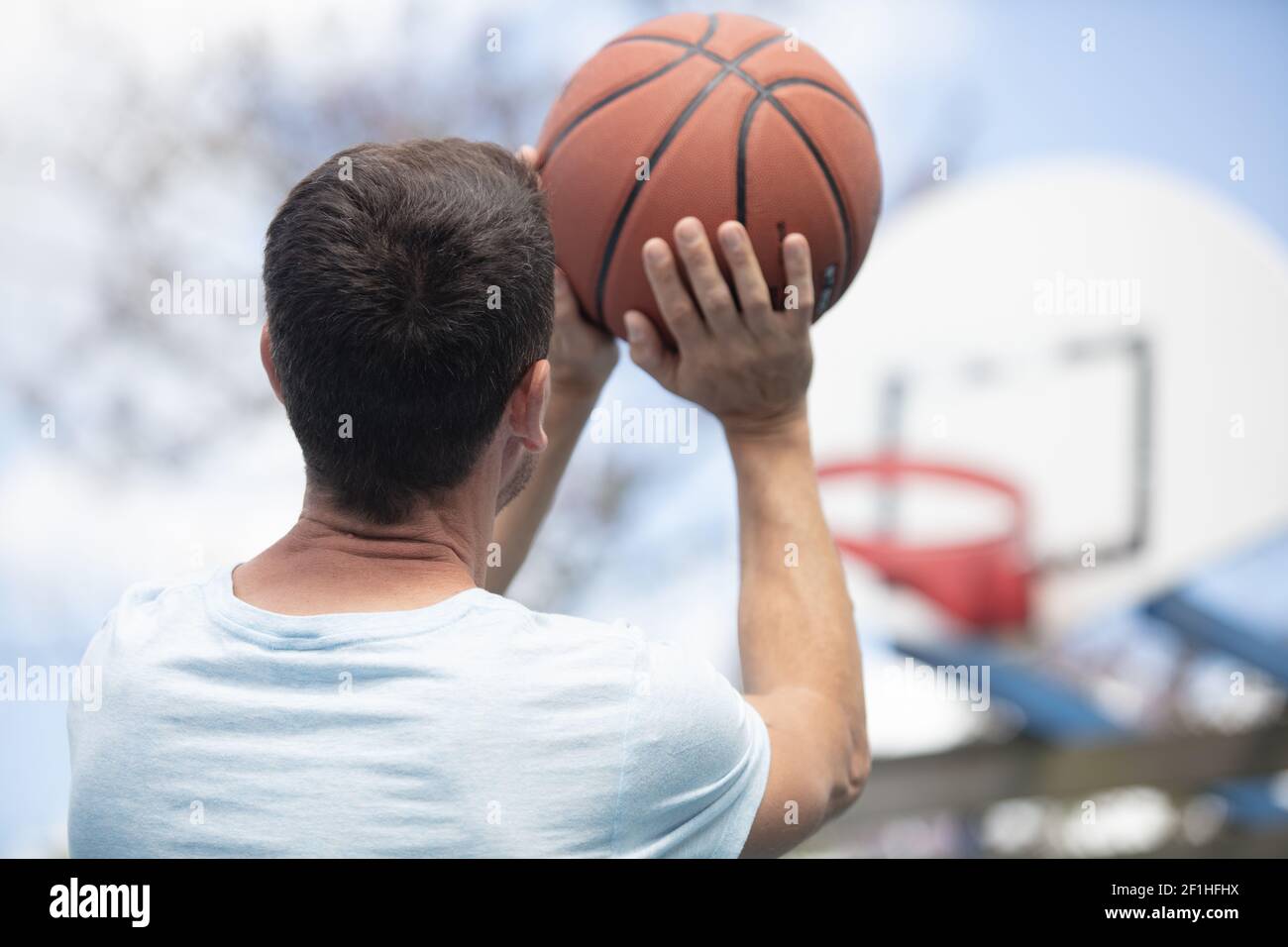 rear-view of man aiming at the basketball net Stock Photo - Alamy