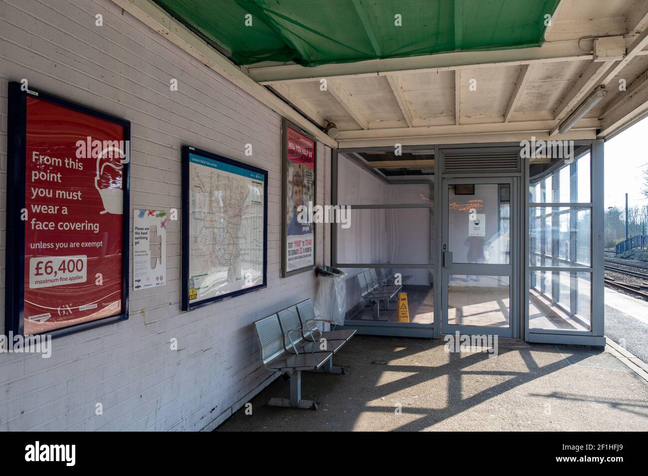 Government information poster at an empty train station, London, "From ...