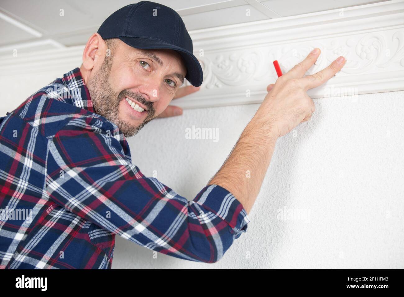 happy plasterer spackling a gypsum plasterboard ceiling with putty ...