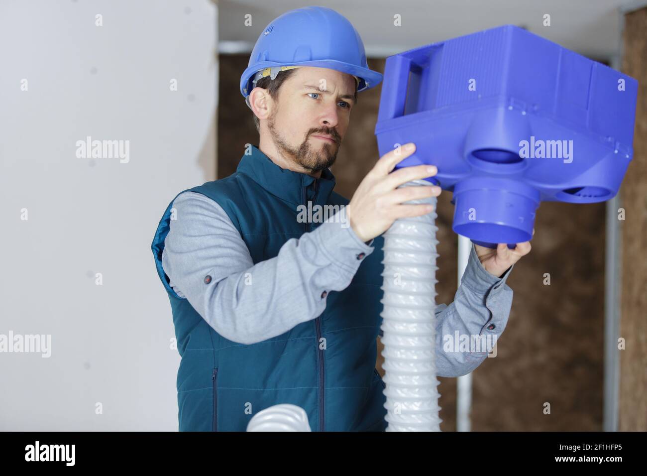 a plumber checking ceiling pipes Stock Photo - Alamy