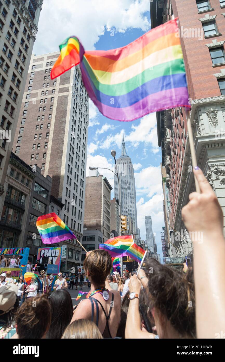 USA, New York, NY - Attendees wave rainbow flags as the watch the New ...