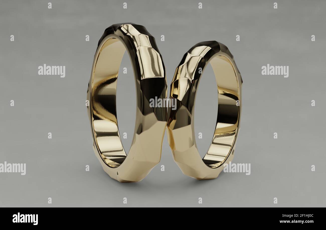 Two golden wedding rings intersected together isolated on white ...