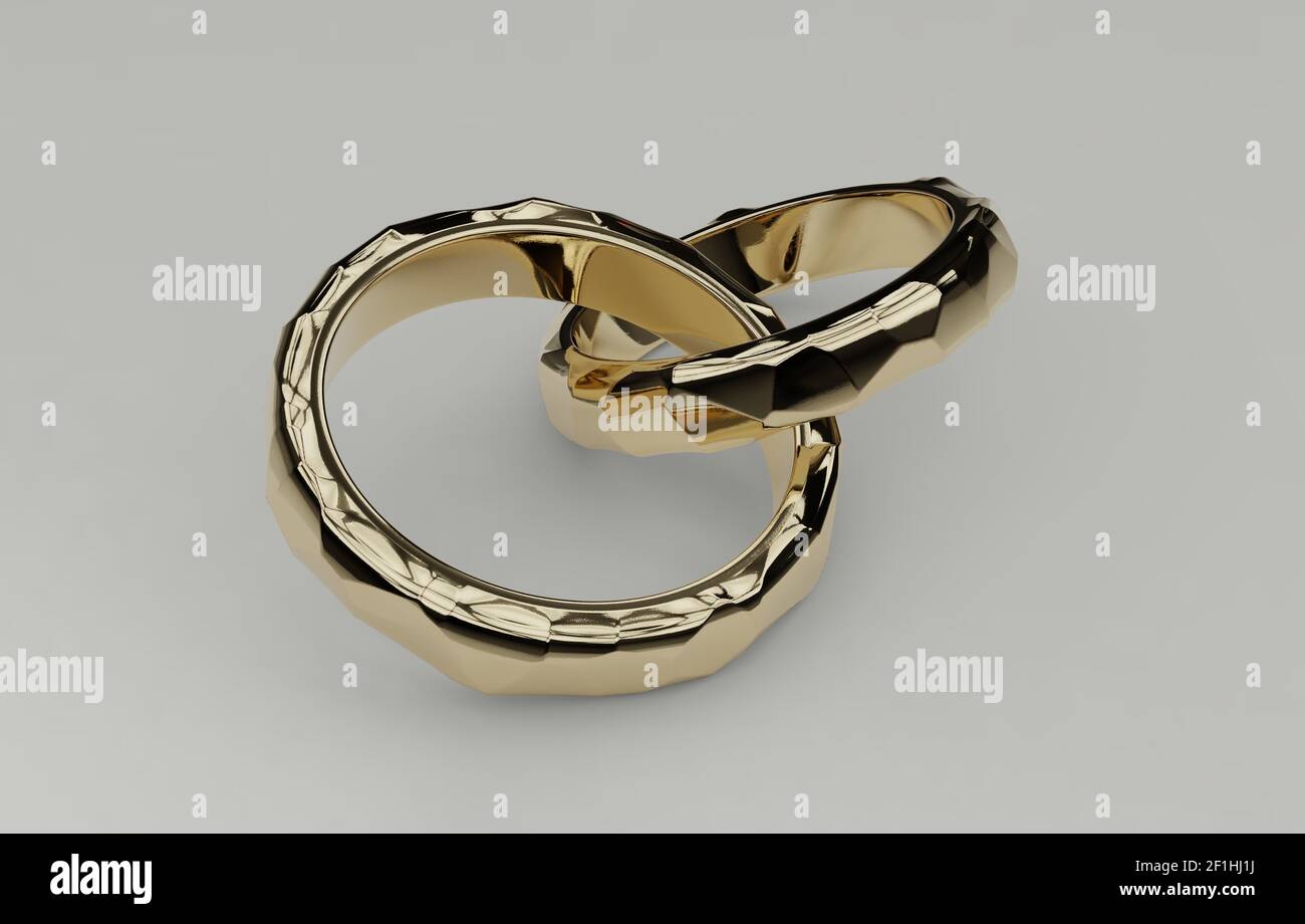 Two golden wedding rings intersected together isolated on white ...