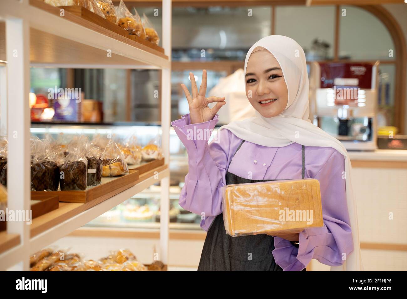 beautiful young woman hijab smiling proudly at her shop Stock Photo - Alamy