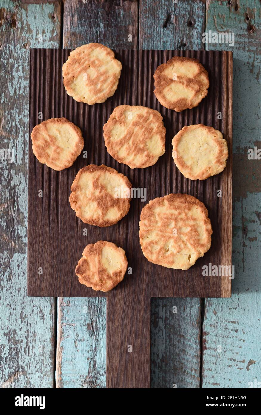Dark oak ribbed board with homemade imperfect cookies on shabby blue ...