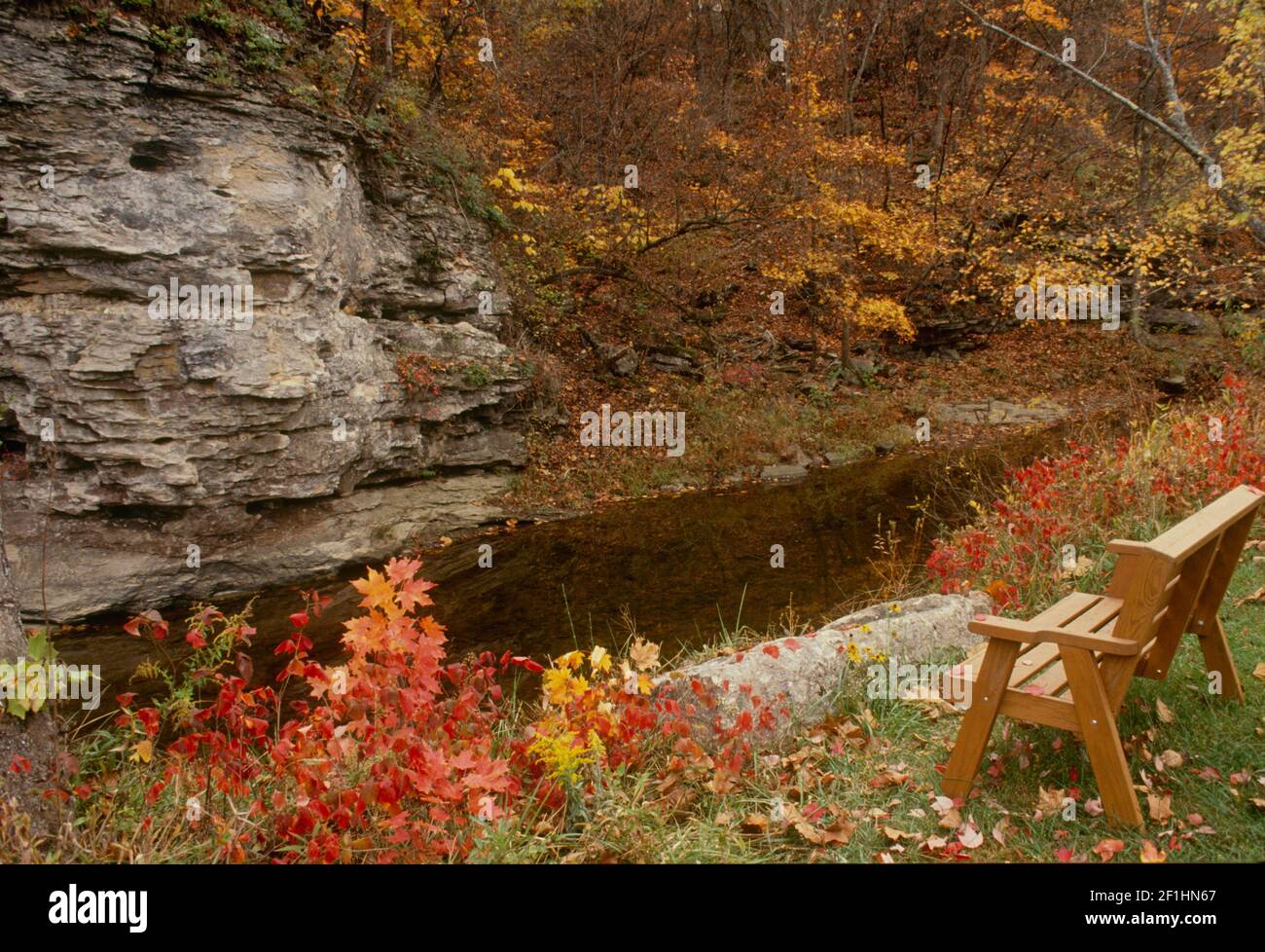 Wooden bench for two overlooking grindstone creek and the facing rock ...