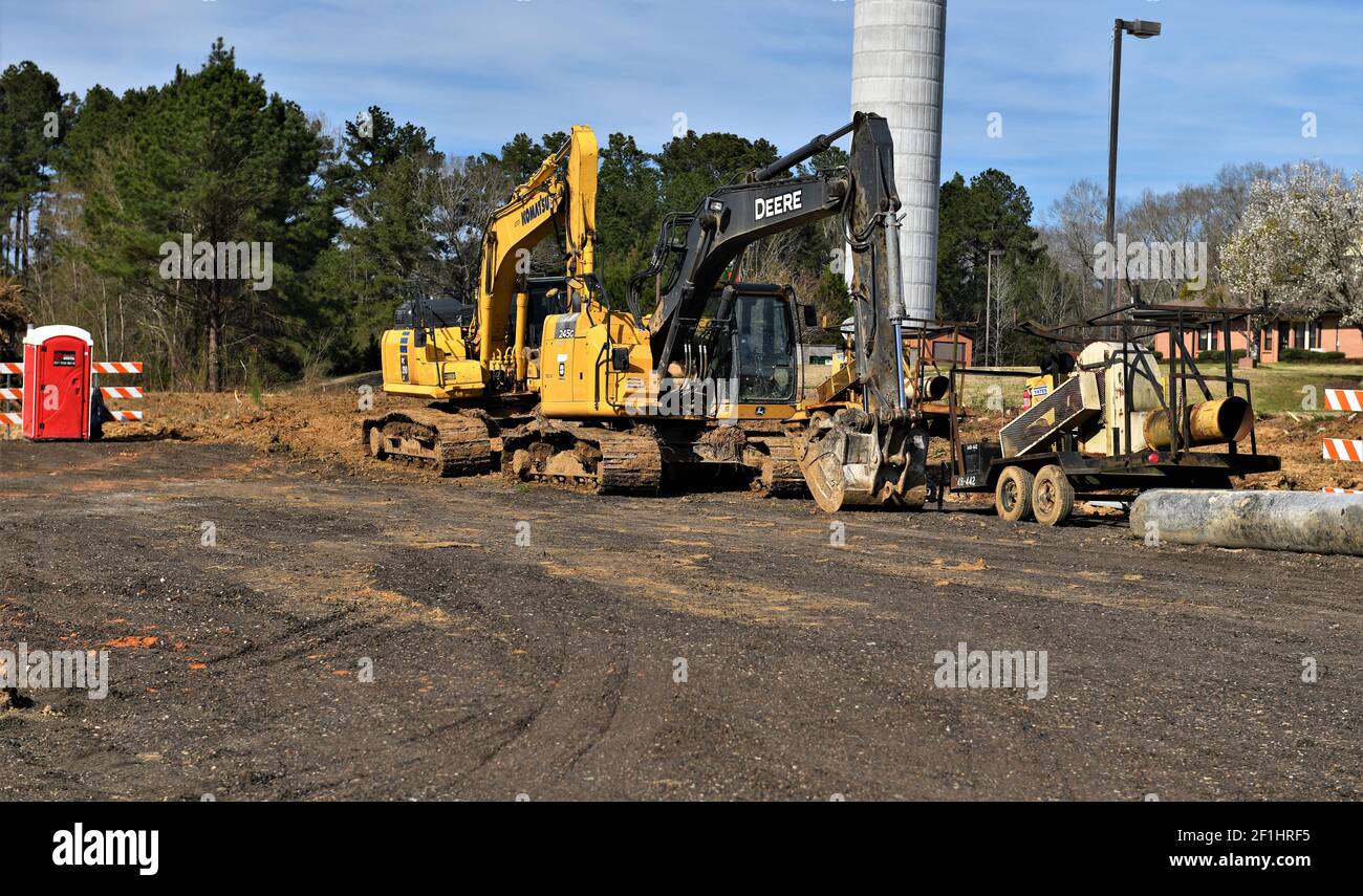 Komatsu and John Deere trackhoe construction equipment Stock Photo - Alamy