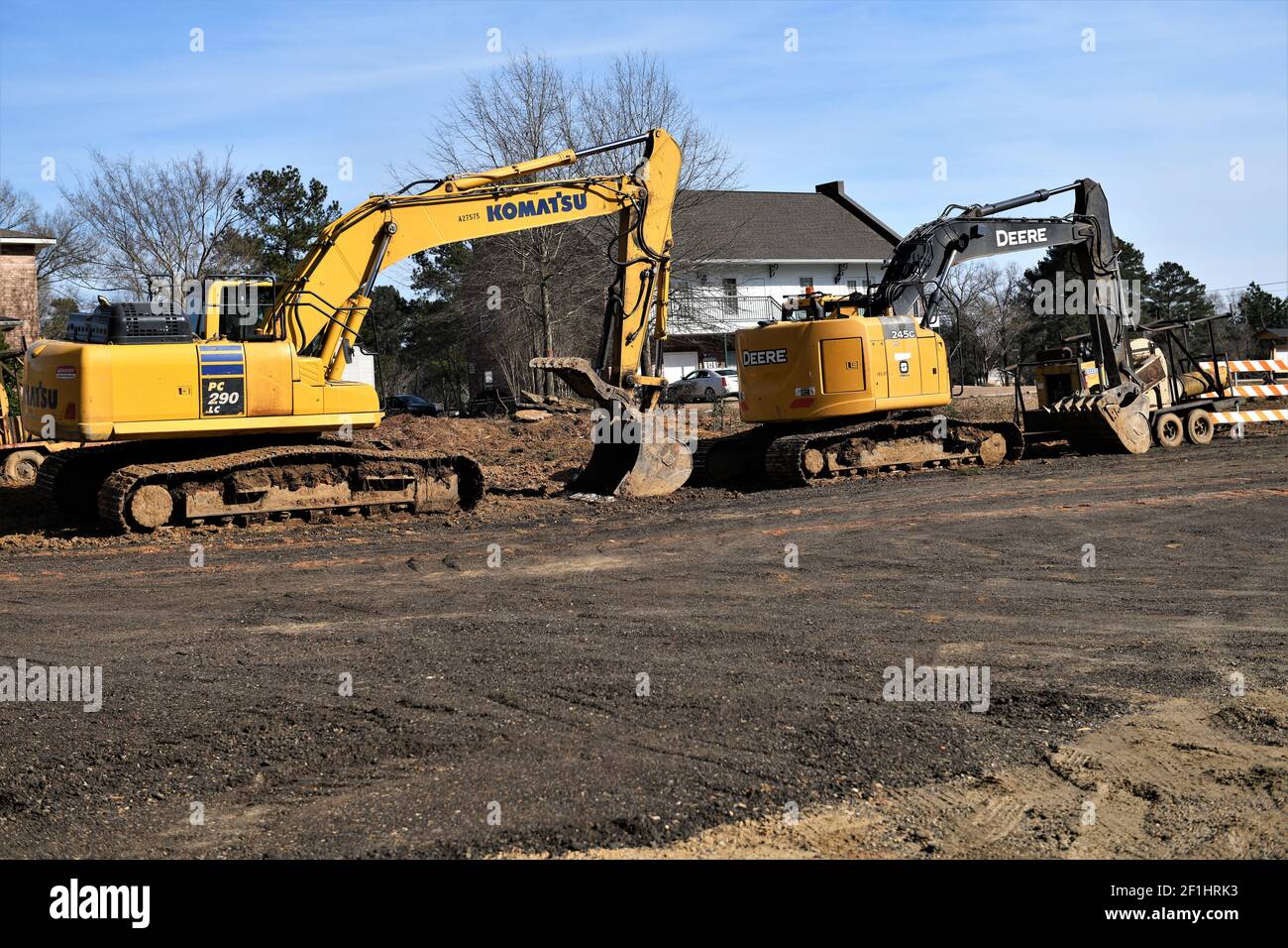 Komatsu and John Deere trackhoe construction equipment Stock Photo - Alamy
