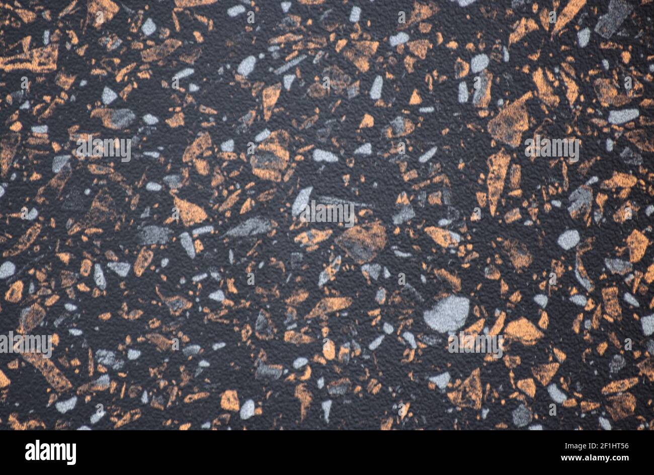 Black granite, polished surface of natural stone with orange and white ...