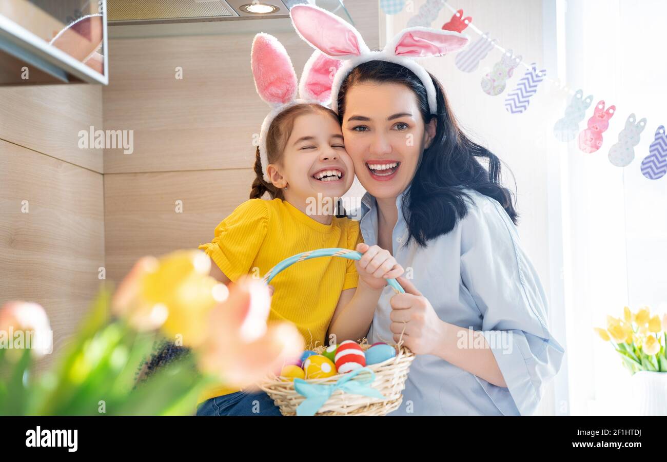 Happy holiday! Mother and her daughter with painting eggs. Family ...