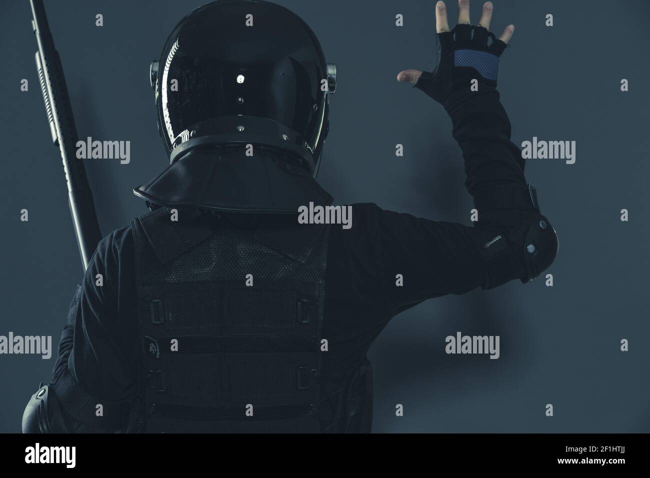 Riot police signaling to colleagues with their hands. armed man with ...