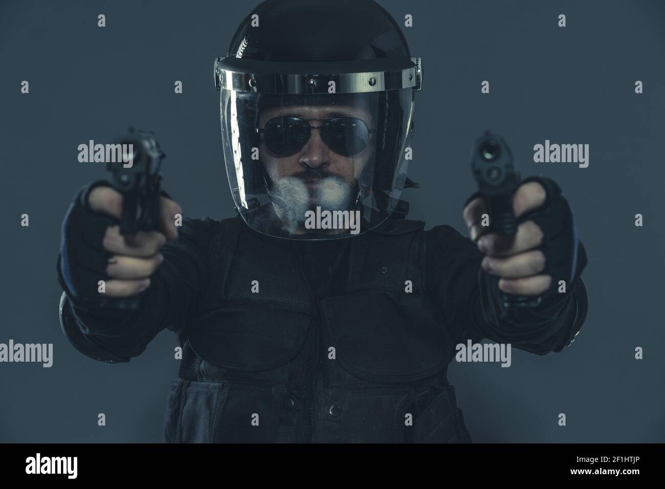 Policeman, riot police signaling to colleagues with their hands. armed ...