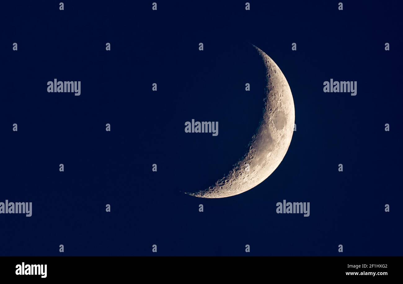 Waxing crescent moon in a dark blue night sky Stock Photo - Alamy