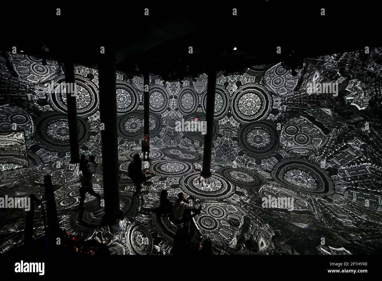 People watch “Geometric Properties” art installation, an immersive ...