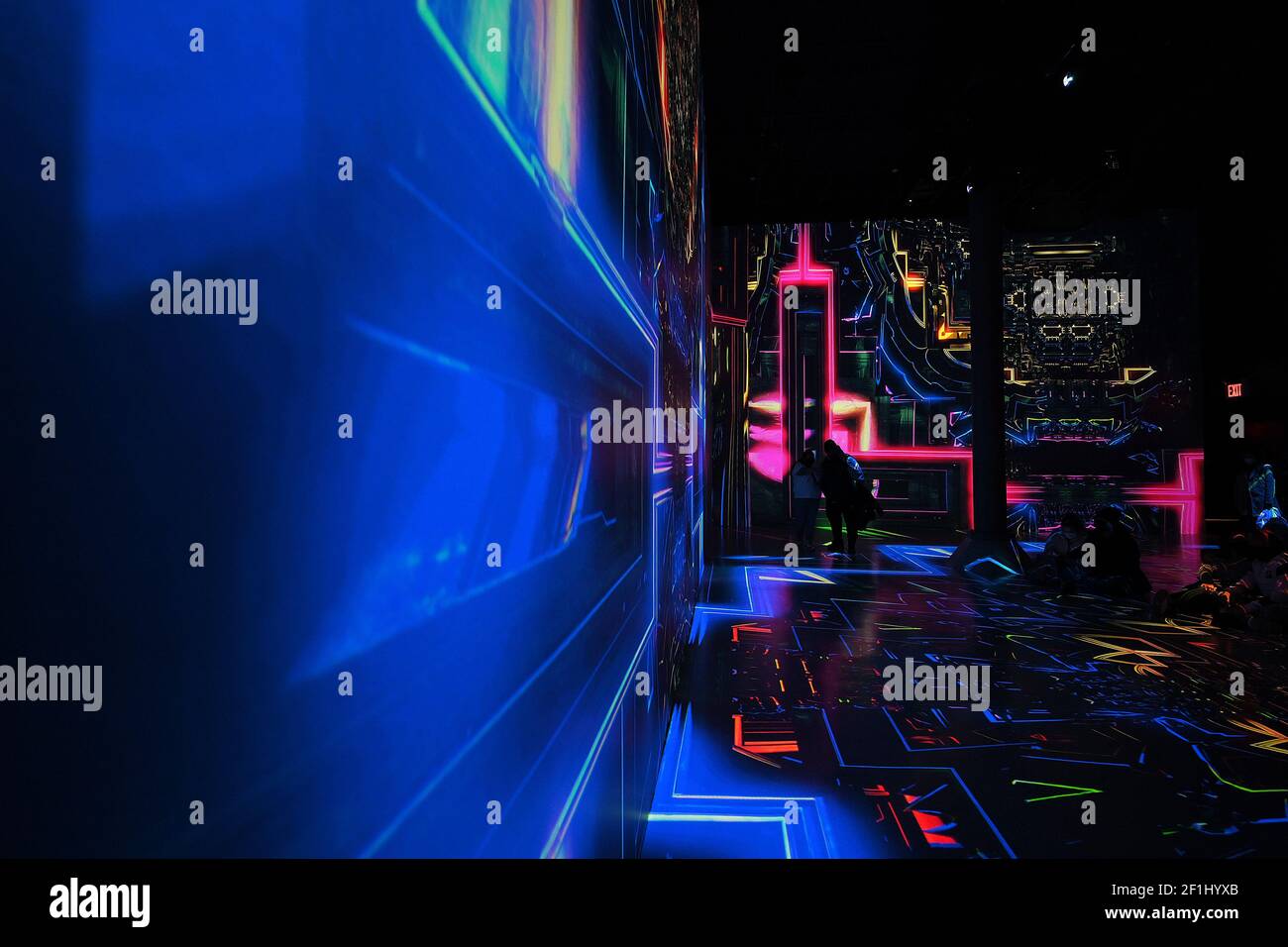 People watch “Geometric Properties” art installation, an immersive ...