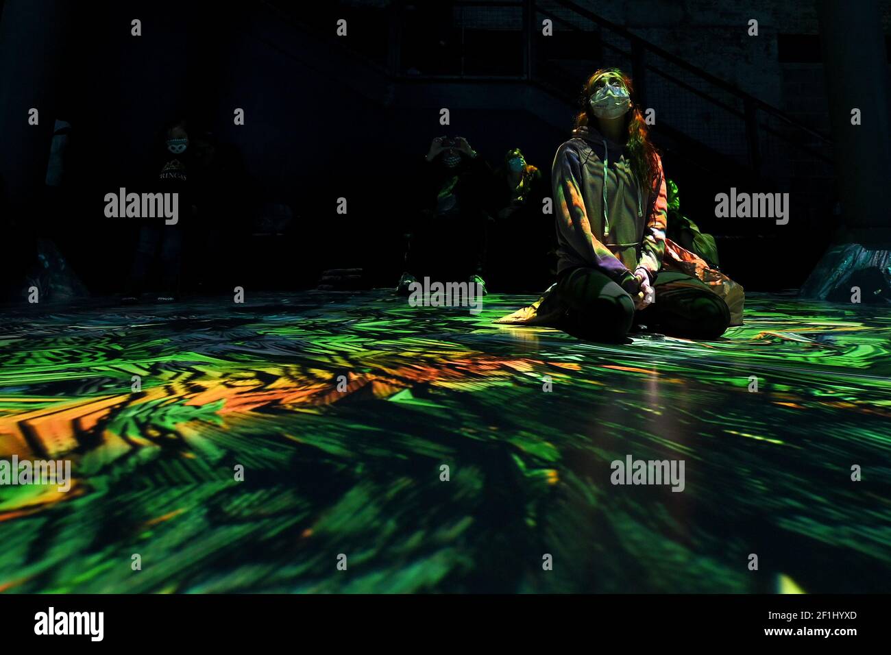 People watch “Geometric Properties” art installation, an immersive ...