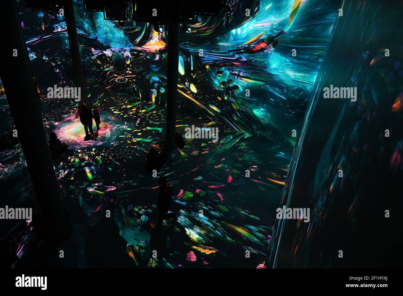 People watch “Geometric Properties” art installation, an immersive ...