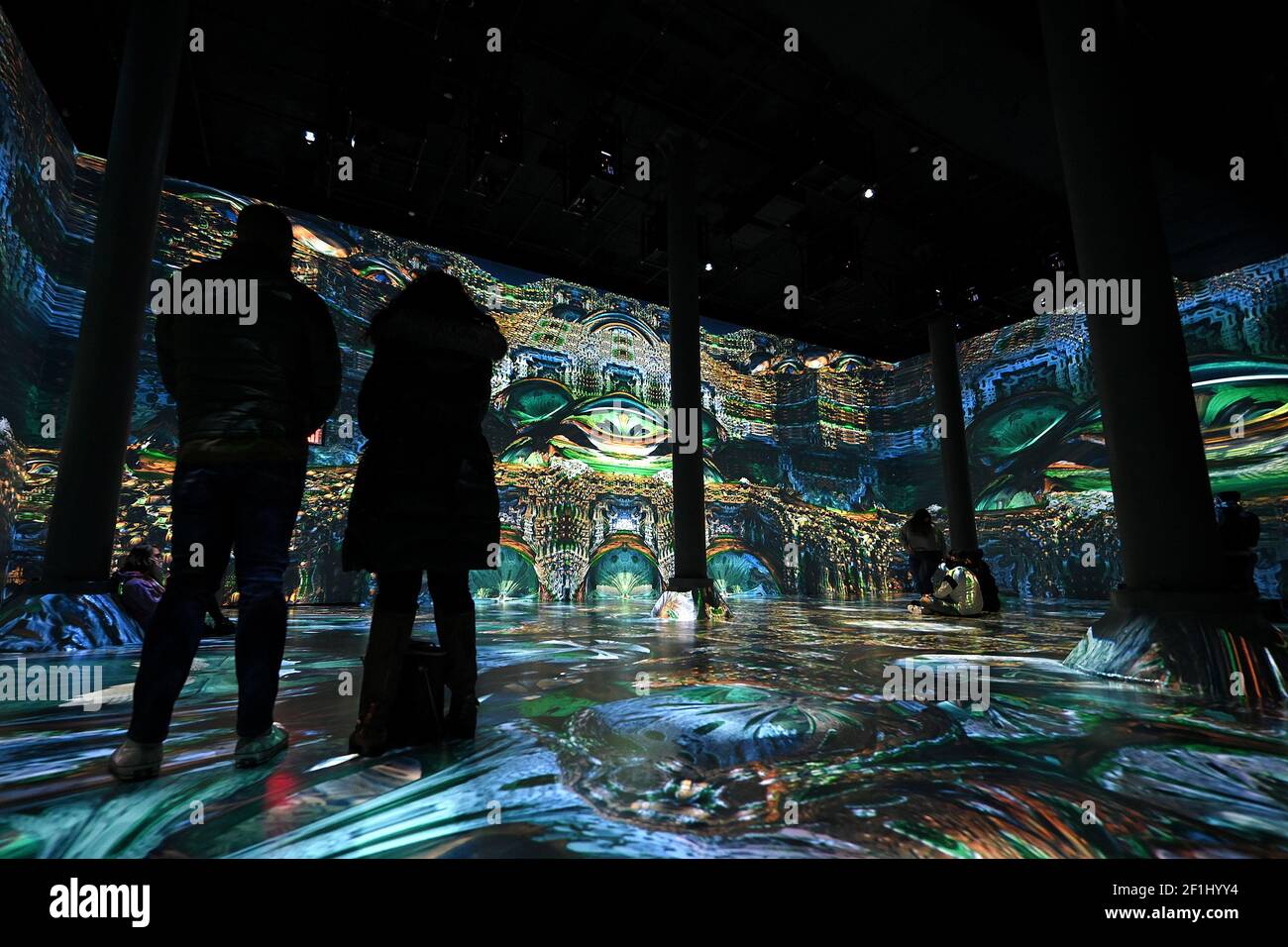 People watch “Geometric Properties” art installation, an immersive ...