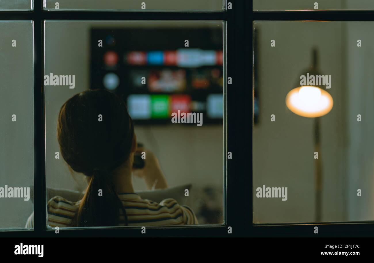 Woman watching tv alone screen hi-res stock photography and images - Alamy