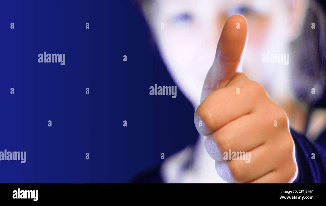 Teenage girl turns her thumb in a positive sense to negative sense ...