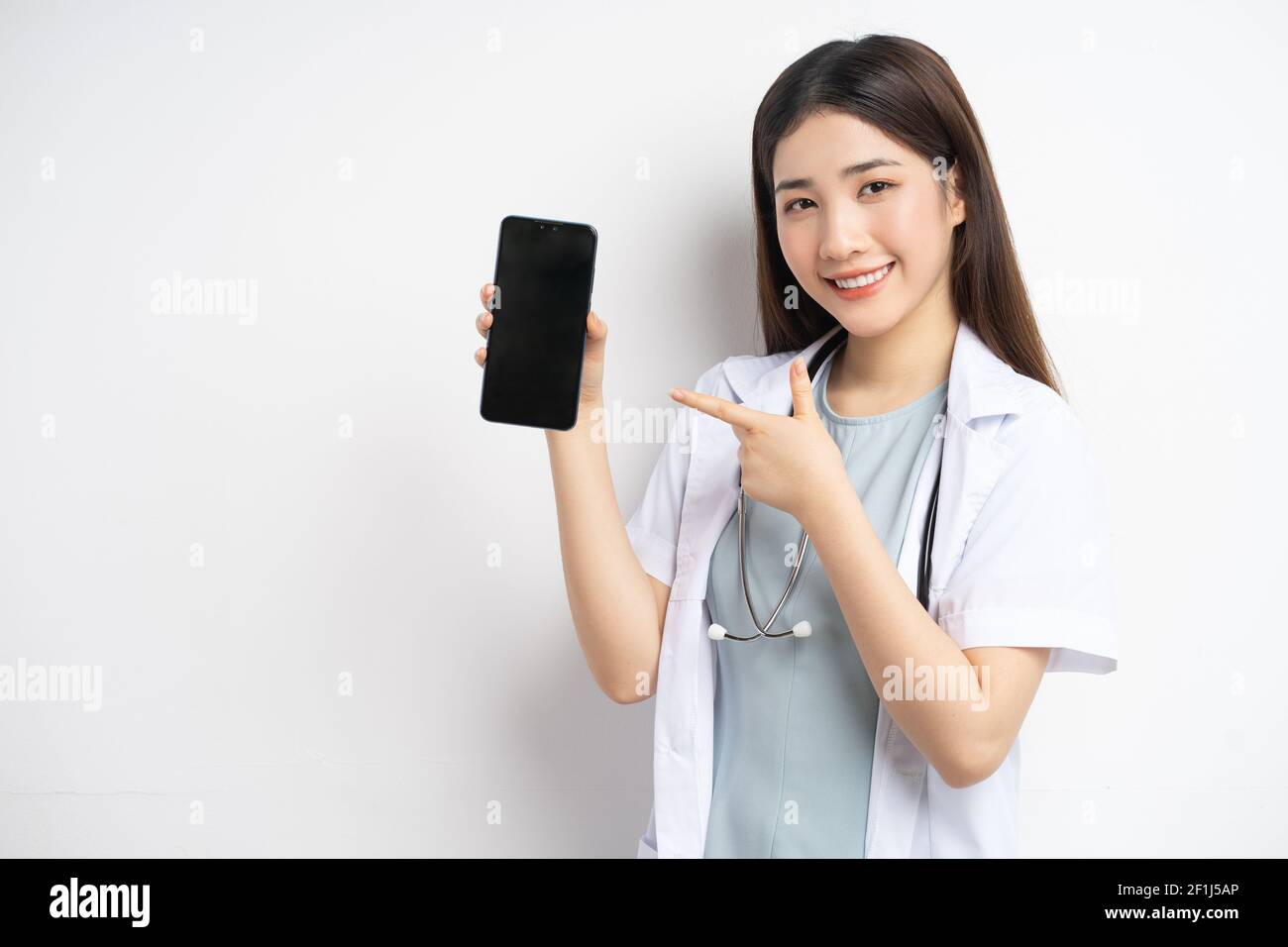 portrait asian female doctor holding phone in hand Stock Photo - Alamy