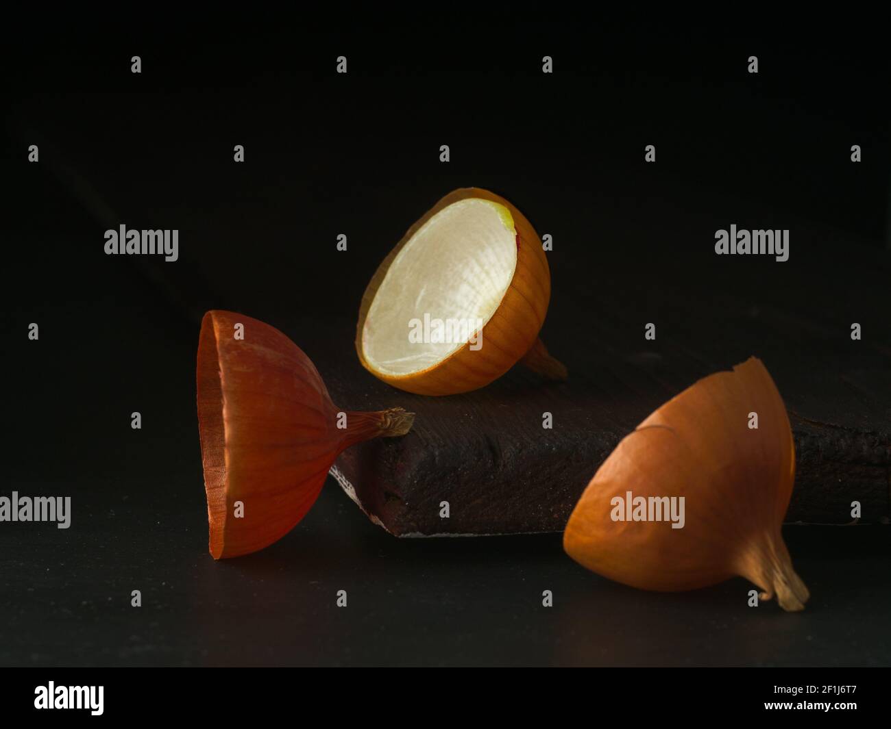 Art composition with half parts of onion husk. Close-up view. Low key ...