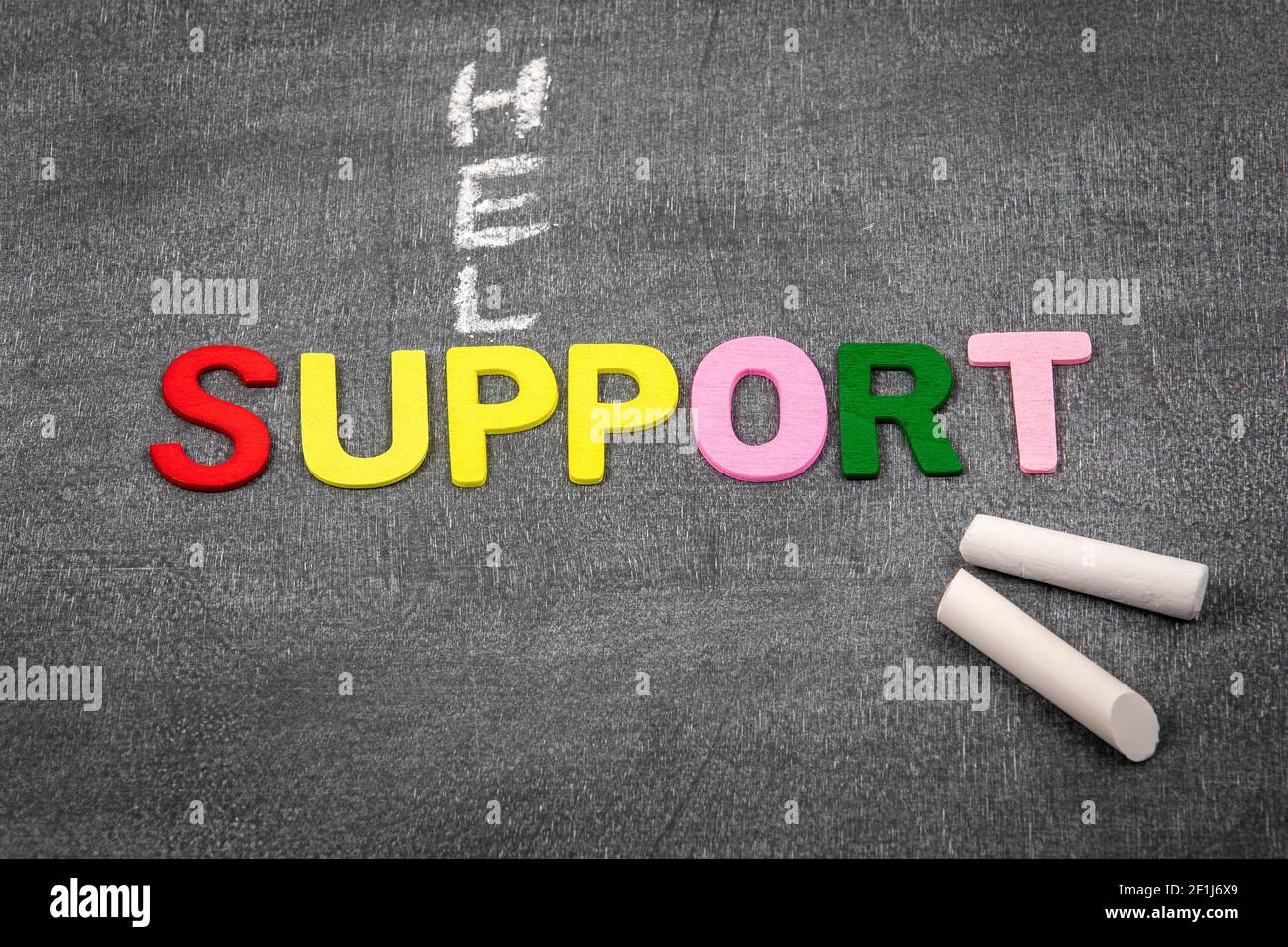 Help and Support concept. Colored letters of the alphabet on a dark ...