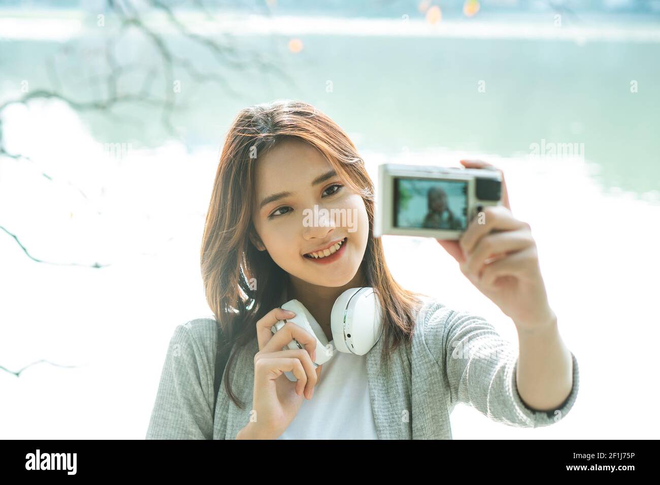 Young girl taking selfie photo during her trip to Hanoi ( Hoan Kiem ...