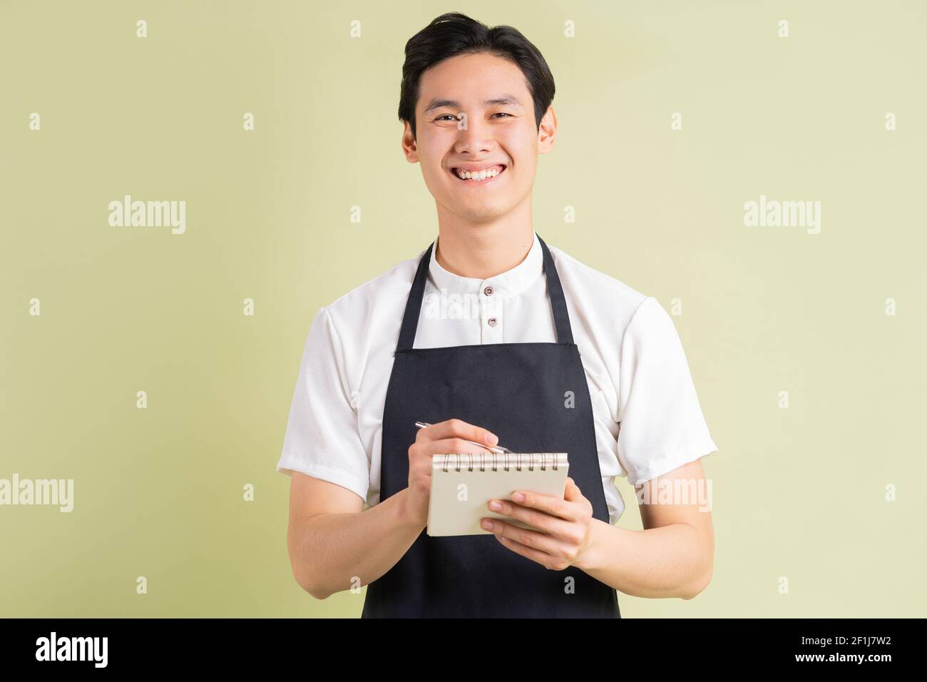 The Asian service staff is recording the customer's request Stock Photo ...