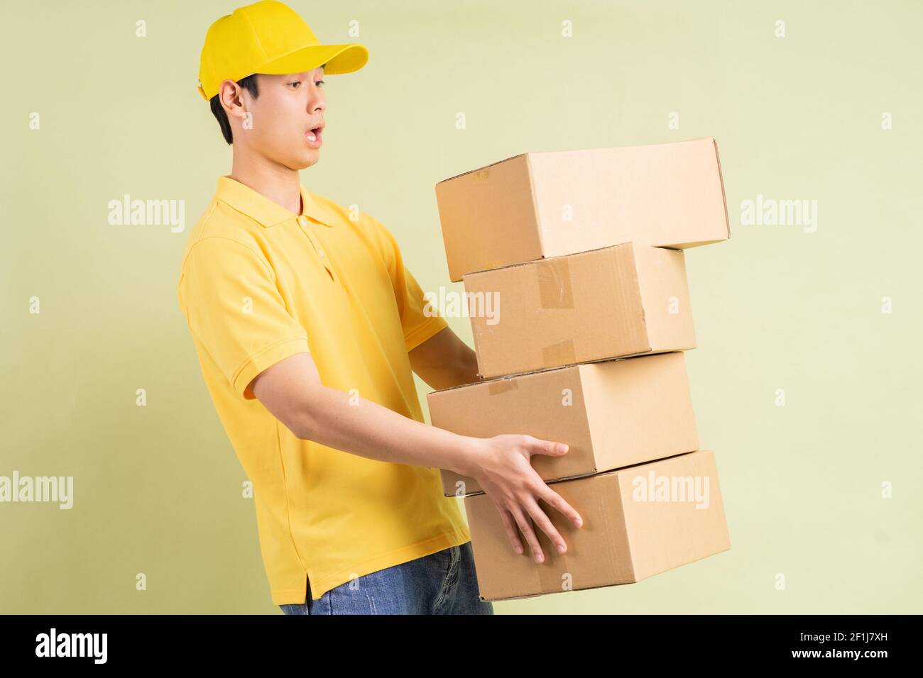 Asian delivery man is holding the carton with him and running to ...