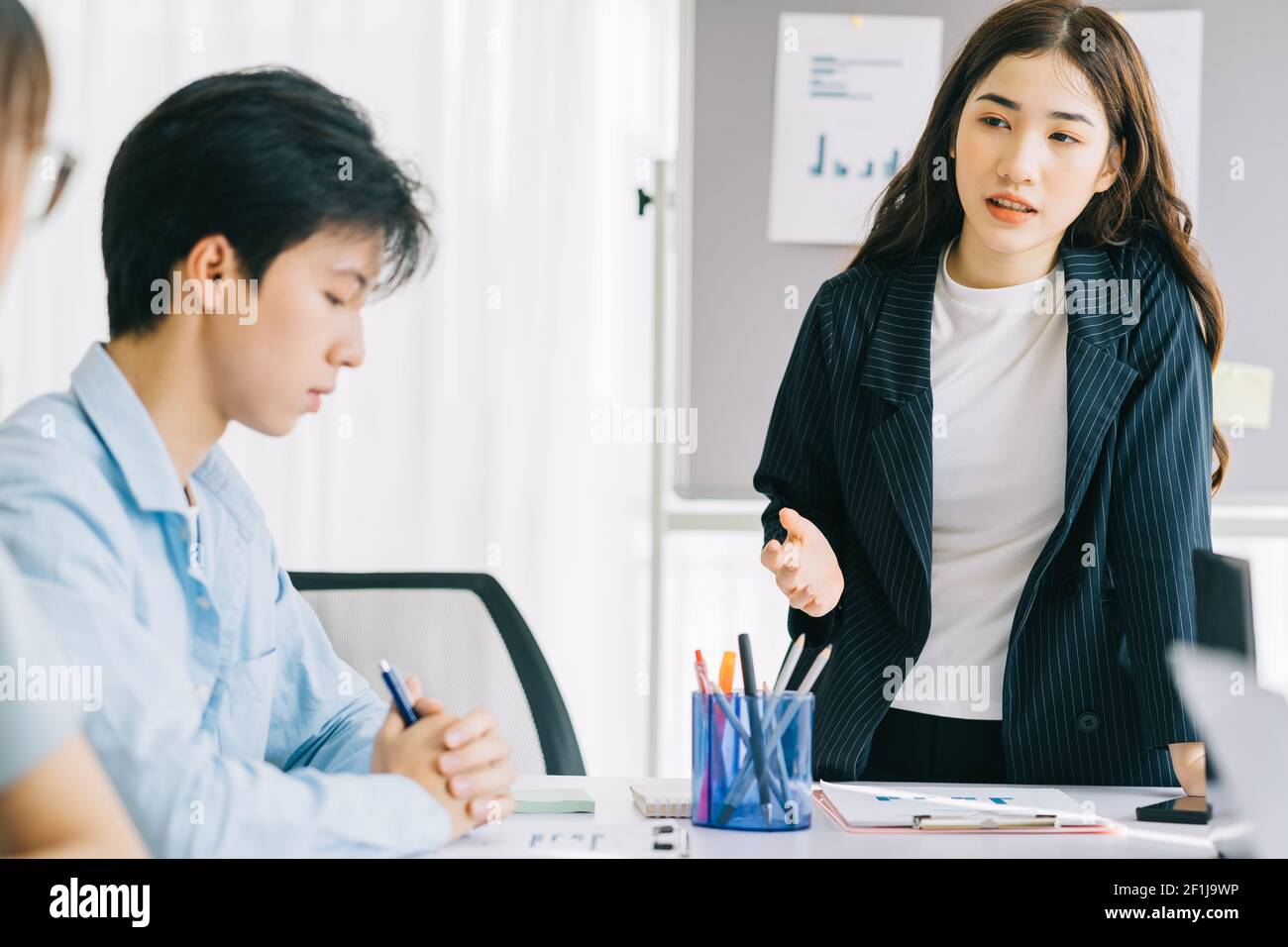 The Asia team leader is giving a presentation to everyone in the ...