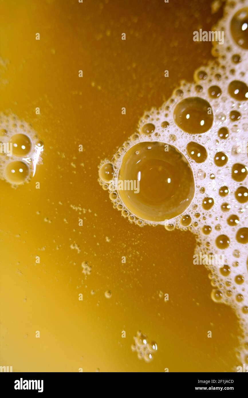 Different size of water bubbles close up modern yellow background high ...