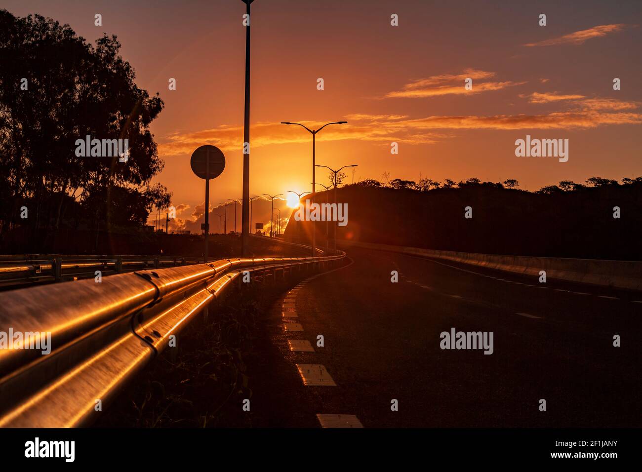 Sunset on highway Stock Photo - Alamy