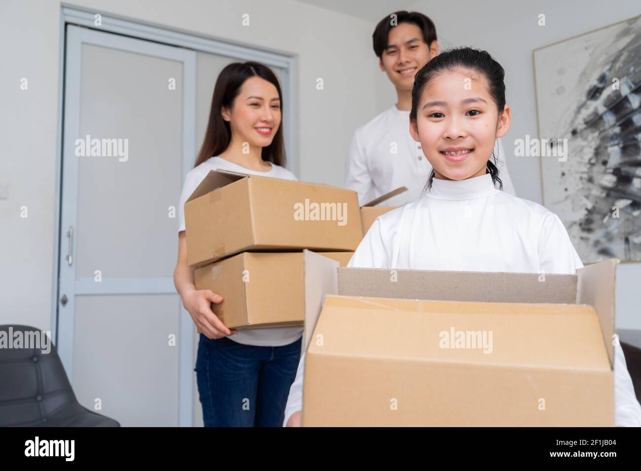 Young Asian families are moving into a new home together Stock Photo ...