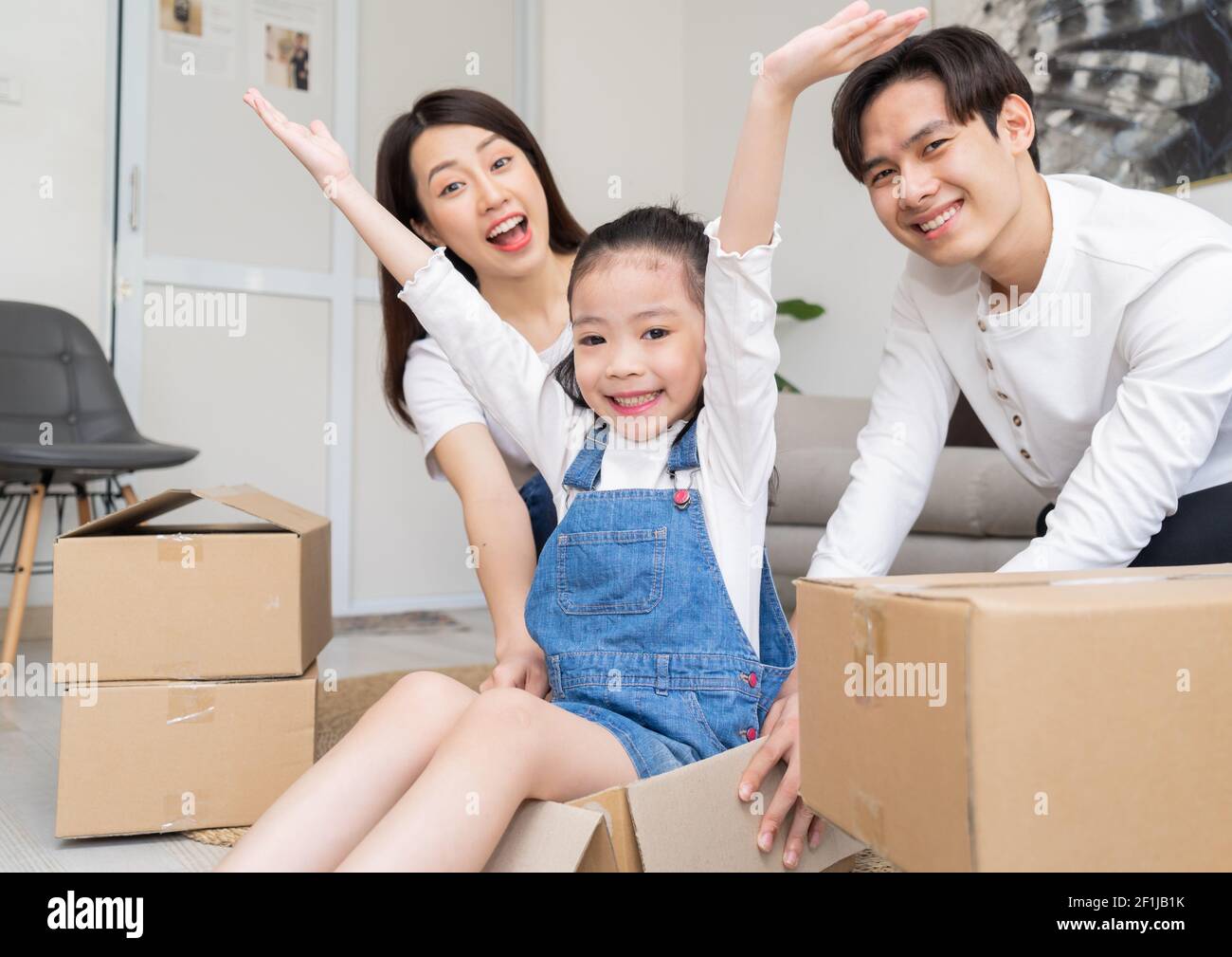 Young Asian families are moving into a new home together Stock Photo ...