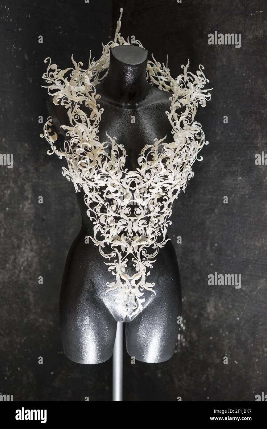 Manikin, Piece made with 3d printer, is composed of white flowers that ...