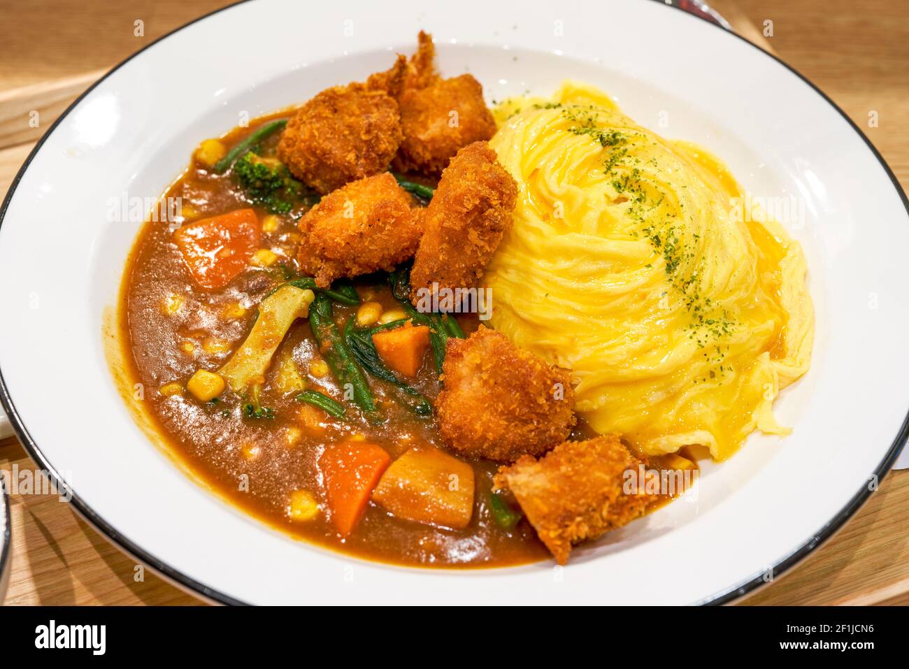 A tempting and delicious Japanese curry fried chicken omelet rice Stock ...