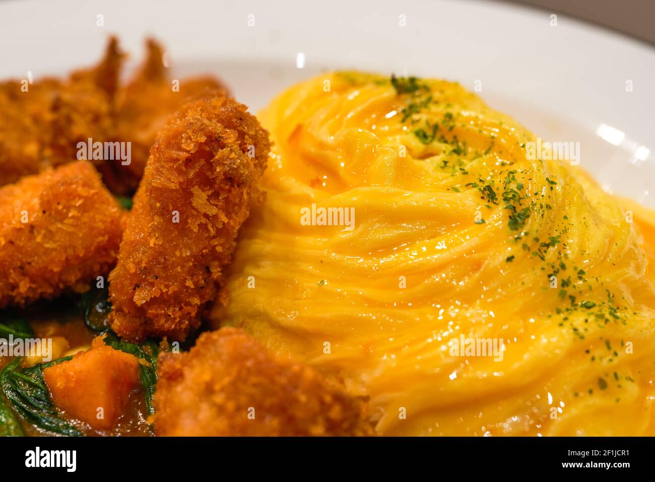 A tempting and delicious Japanese curry fried chicken omelet rice Stock ...