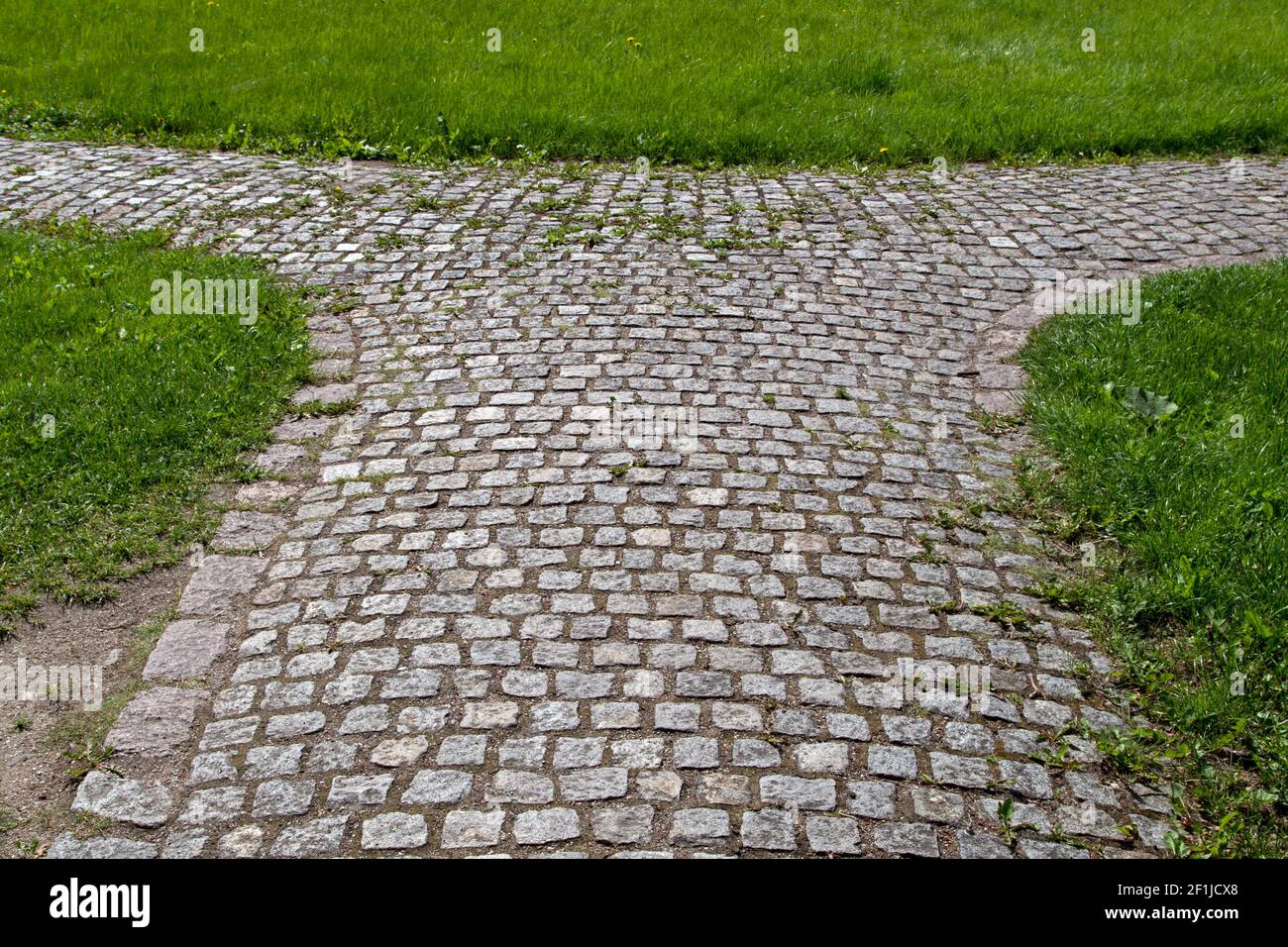 Paved with blue square rough stones, the road splits in two directions ...