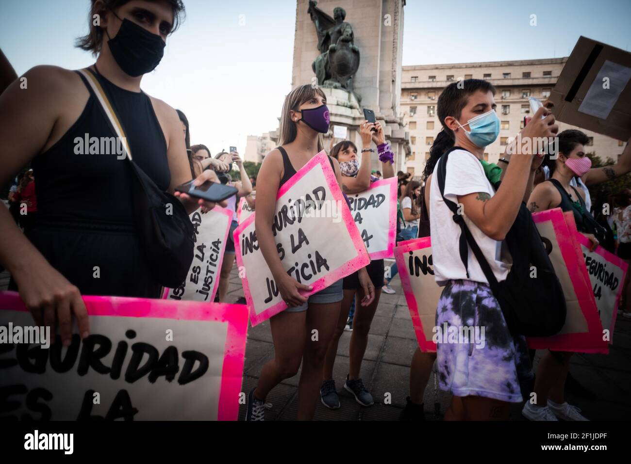 Women hold placards saying insecurity is justice during the march ...