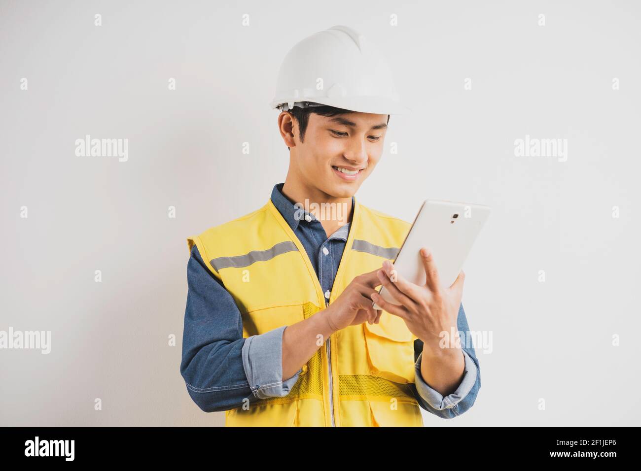 Asian construction engineer reading the technical drawing Stock Photo ...
