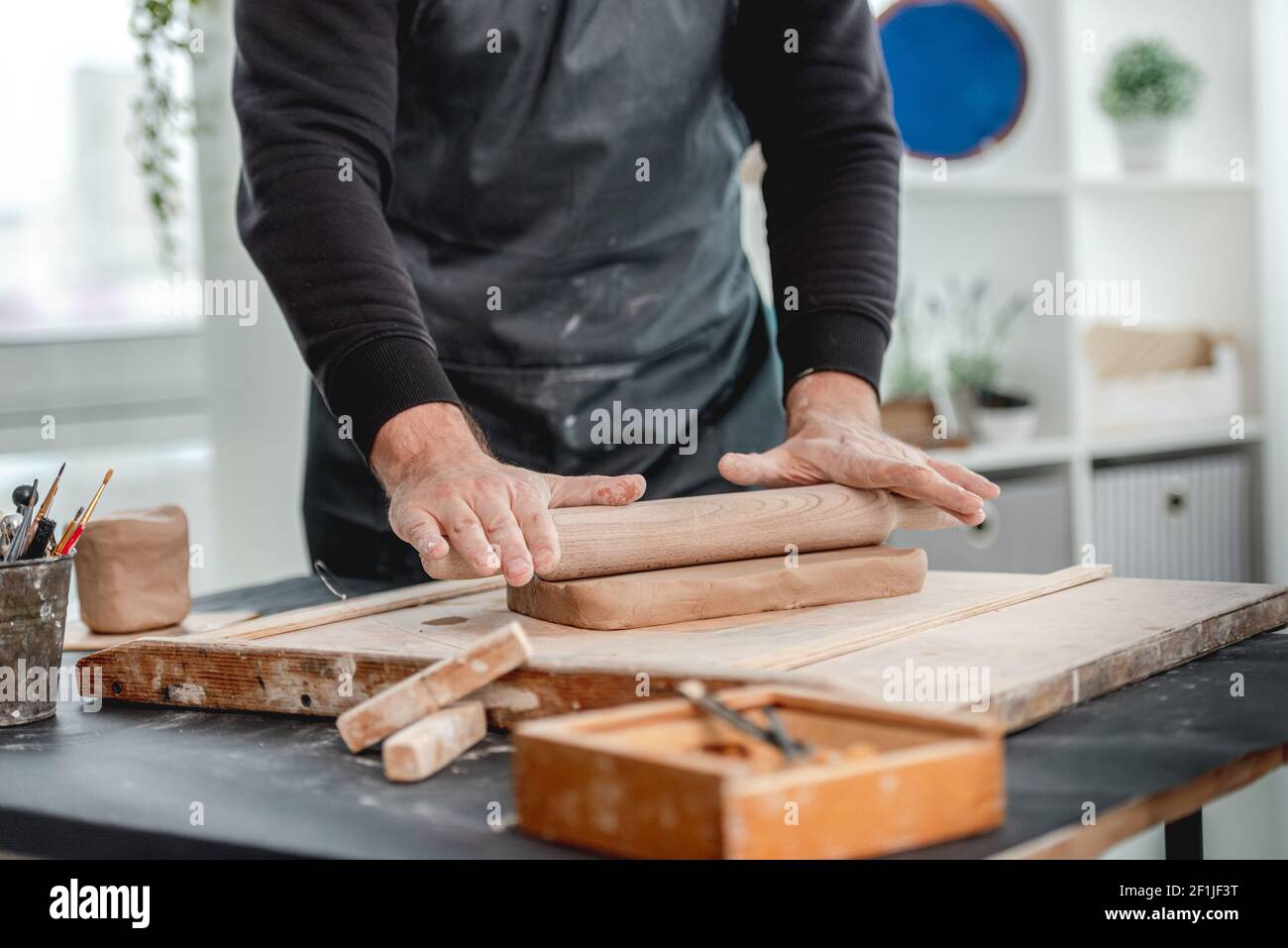 Man forming mold from pottery clay Stock Photo - Alamy