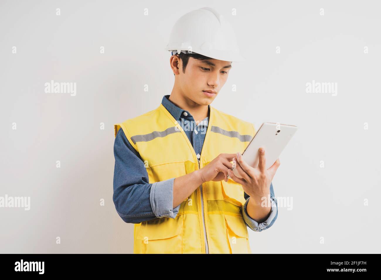Asian construction engineer reading the technical drawing Stock Photo ...